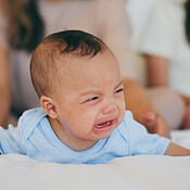 Crying, sad or baby with mother in bed for comfort, safety and ...