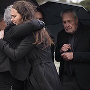 Funeral, crying family and people hug for grief support, mourning ...
