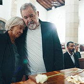 Funeral, coffin and senior couple hug in church for goodbye, mourning ...