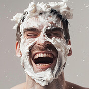Man, smile and foam on face in studio with skincare for wellness with ...