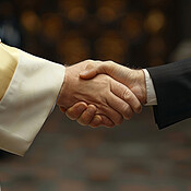 Handshake, priest and business man with agreement, secret deal and ...
