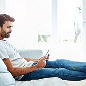 Mellowed out with modern technology | Buy Stock Photo on PeopleImages ...