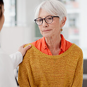 Healthcare, shoulder pain and a senior woman with her doctor in the ...