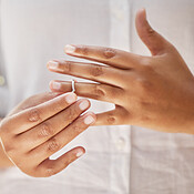 Close up of female hands removing wedding ring. Woman taking off ring ...