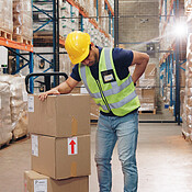Back pain, man and boxes in warehouse for injury, overworked and strain ...