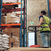 Pallet truck, man and box in warehouse with transport, safety and ...