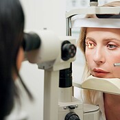 Woman, optometry and slit lamp with machine, vision or care in wellness ...