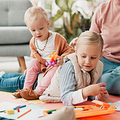 Kids, parents and drawing for education on floor with family bonding ...