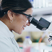 Medical, research and woman with microscope, biotech and check ...