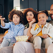 Family, kids and watching tv together in home for bonding, streaming ...