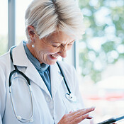 Mature woman, doctor and laughing with tablet for telehealth, medical ...