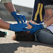 Paramedic, accident and hands on head injury on road in car crash ...