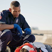 Paramedic, emergency and talking on road from car crash accident with ...