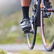 Closeup of one woman cycling outside. Sporty fit female athlete with ...