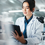 Healthcare, woman and scientist with tablet in lab for microscope ...