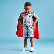 Full length portrait of a brave little boy in superhero cape and mask ...