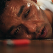 Drugs, blackout and man with face on table, health risk and narcotic ...