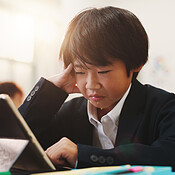 School, tablet and sad child with stress, leaning and development in ...