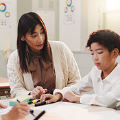 Sad, education and child with teacher, classroom and help for dyslexia ...