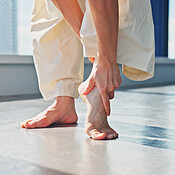 Injury, legs and dancer in studio, hurt and fracture on ankle, joint ...