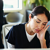 Headache, stress and woman receptionist at medical front desk for ...