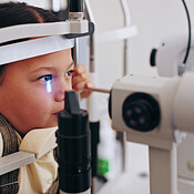 Specialist, child and eye care examination with ophthalmoscope for ...