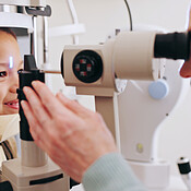 Doctor, child and examination with slit lamp for retina assessment, eye ...