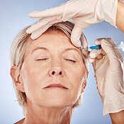 Skincare, mature woman and botox injection from healthcare professional ...