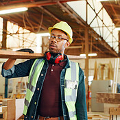 Black man, carpenter and carry wood at workshop of manufacturing ...
