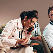 Audience, distraction and phone call with business people in auditorium ...