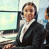 Control room, woman and portrait with headset by screen, monitor ...