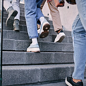 Feet, students and walking on stairs at school for education, learning ...