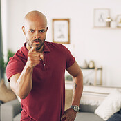 Pointing, serious and portrait of man in home for discipline, blame or ...