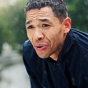 Fitness, man and tired with breathing at park for running burnout ...