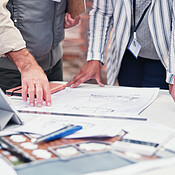 Construction site, people and documents for floor plan, blueprint and ...