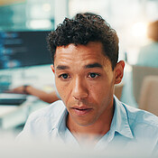 Coding, reading and man on computer in office for problem solving, web ...