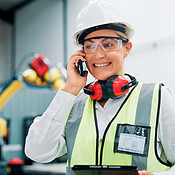 Phone call, engineer and woman with smile, talking and communication ...