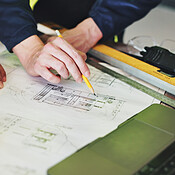 Blueprints, hands and writing with construction worker people closeup ...