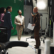 Director, script and instructions to actor on set for creative guidance ...