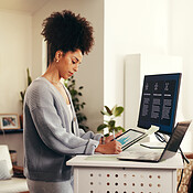 Remote work, tech and graphs with woman in home office for virtual ...