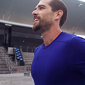 Athlete, man and tired with breathing at stadium for fatigue, race ...
