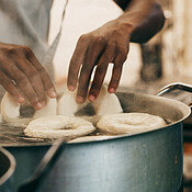 Chef, hands and bagels cooking in water for restaurant food, boiling ...