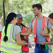 Group of community service volunteers preparing to clean a local park ...