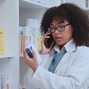 Pharmacist on a phone call talking, chatting and explaining medicine ...