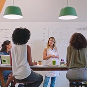Women in marketing company, watch presentation and use whiteboard to ...