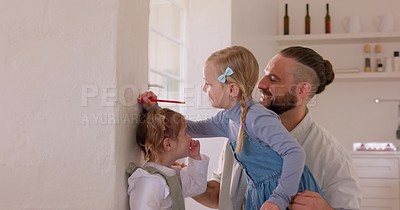 Children check height growth with father on the wall in the house for ...