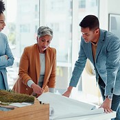 Architecture, team and collaboration of architects talking blueprint ...