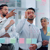 Meeting, collaboration and sticky notes with a business man training a ...