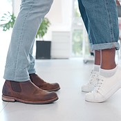 Closeup, shoes and couple in tiptoe moment, romance and sweet relationship in their home. Feet ...