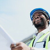Black man, architect and blueprint in city for planning, construction ...